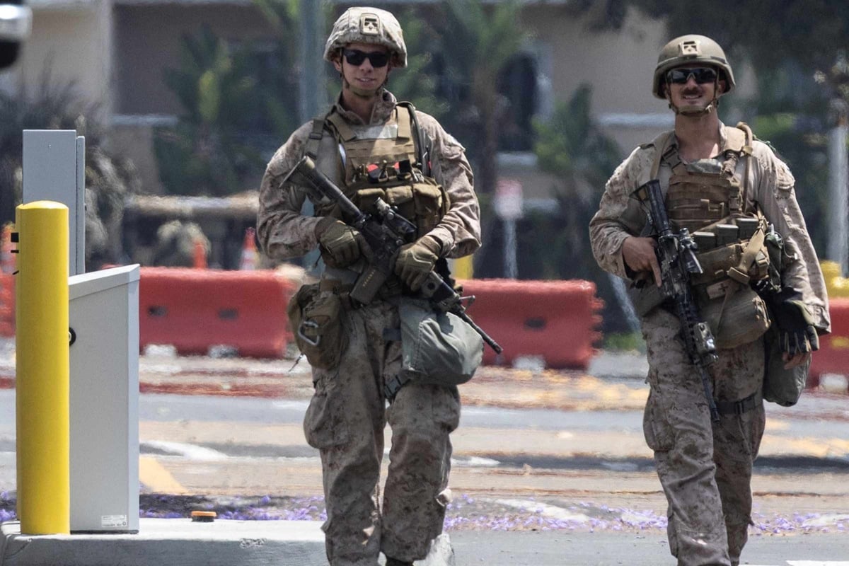 First wave of marines deployed by Trump arrive in LA amid protest standoff