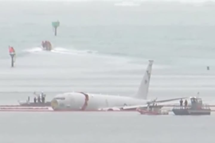 Military plane overshoots runway and crashes into the sea